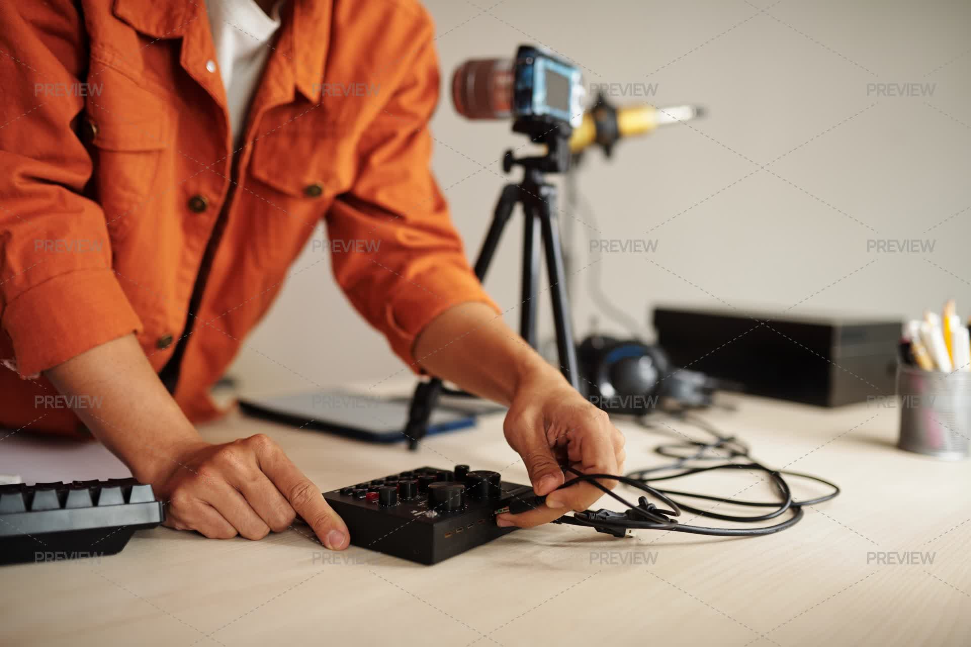 Blogger Inserting Mic Cable Into Mixer - Stock Photos | Motion Array Blogger Inserting Mic Cable Into Mixer - Stock Photos | Motion Array