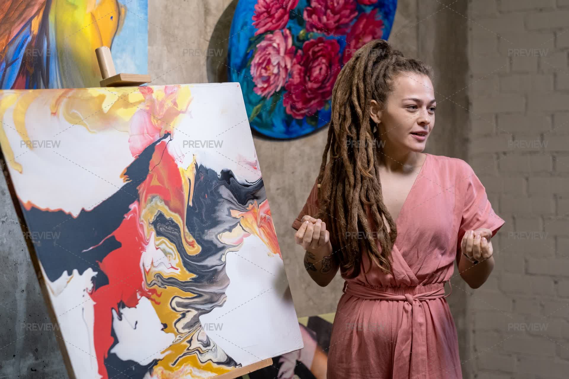 Female Artist Describes Abstract Painting - Stock Photos | Motion Array Female Artist Describes Abstract Painting - Stock Photos | Motion Array